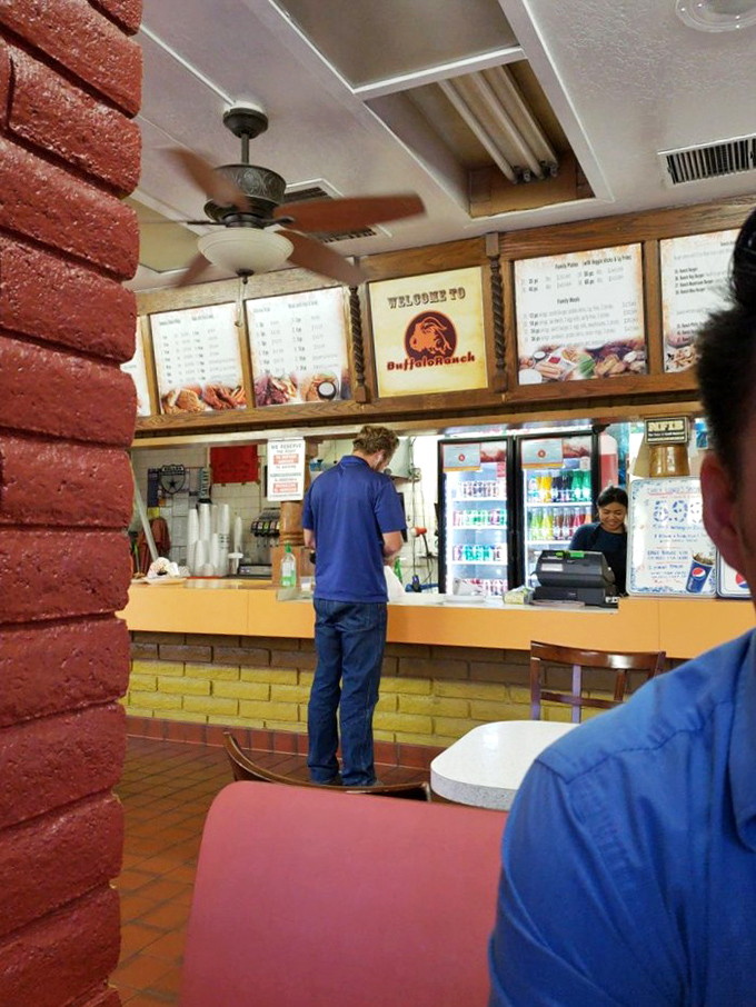 A customer in their natural habitat: surrounded by wings, lost in flavor nirvana. We've all been there!