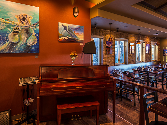 The piano waits patiently in the corner, while local artwork adorns warm-toned walls – a feast for the eyes before the feast for your stomach.