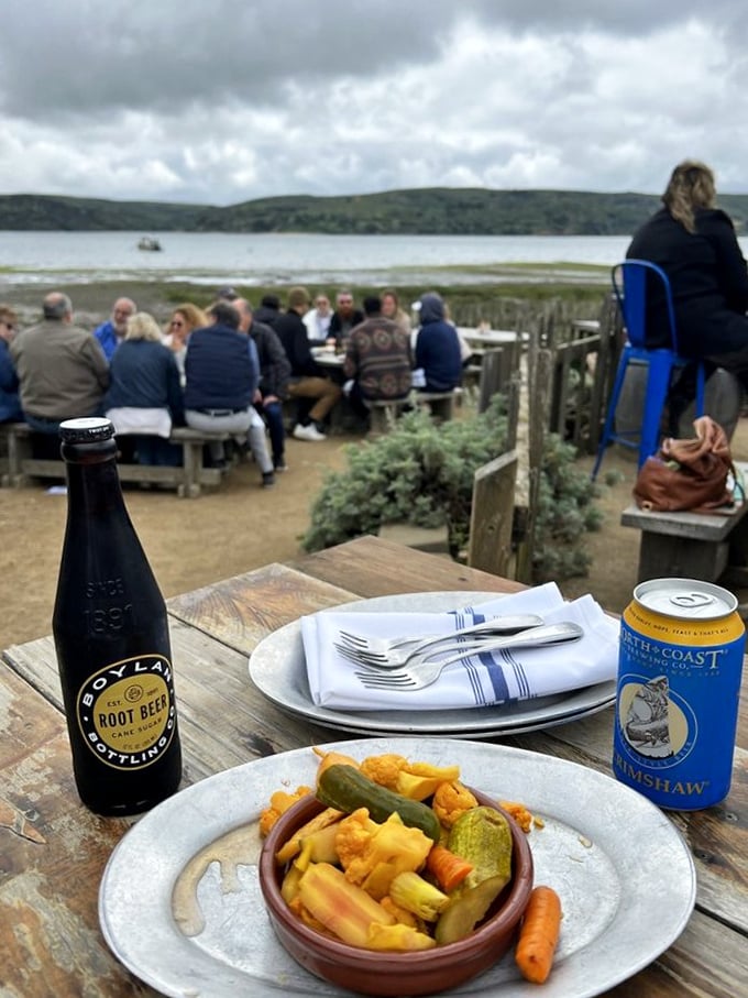 Seafood with a view! These happy diners are living their best lives, feasting on nature's bounty with Tomales Bay as their backdrop.