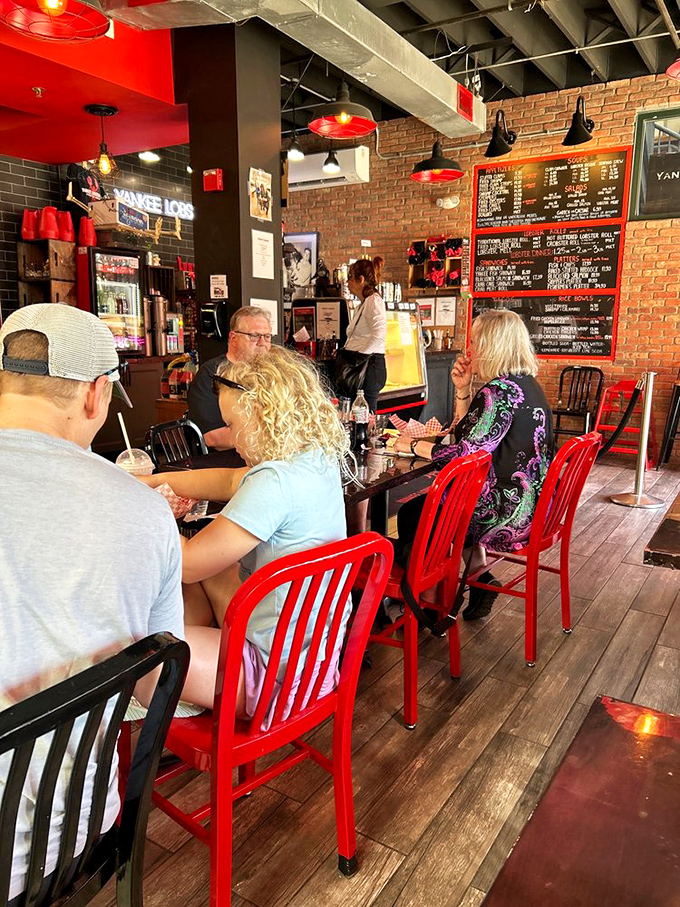Happy diners, red chairs, and seafood galore. It's like a Norman Rockwell painting, but with more butter and fewer calories burned.