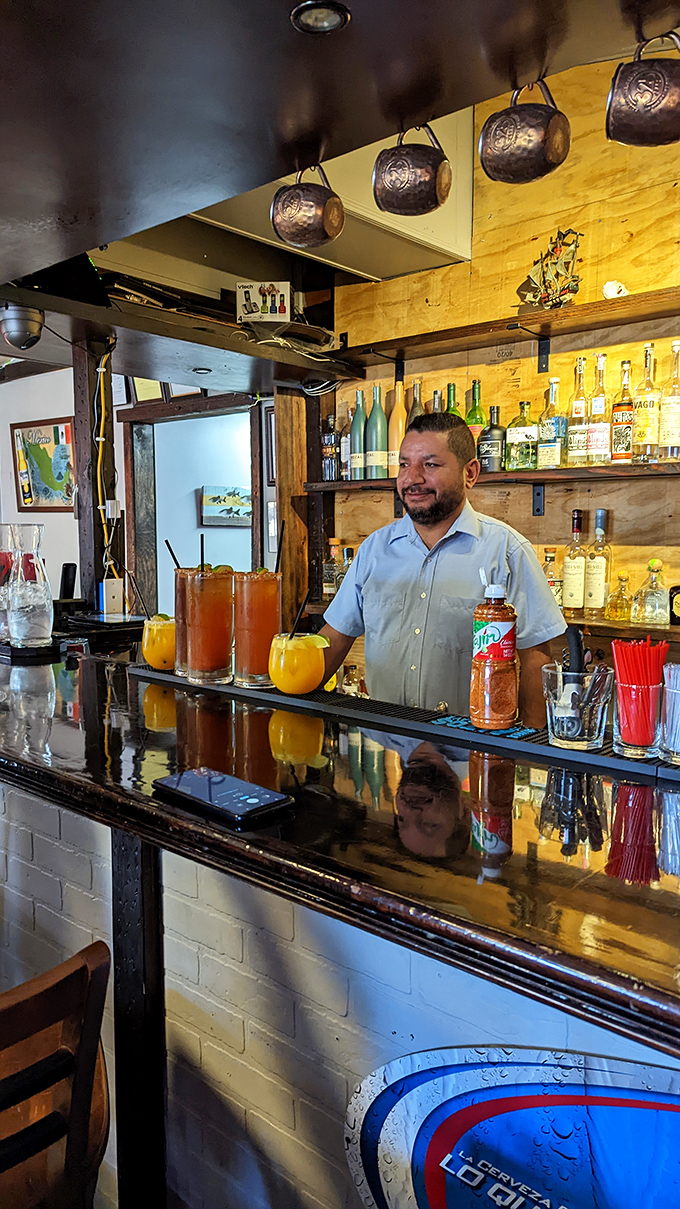 Behind the bar, where liquid magic happens. This mixologist's got more tricks up his sleeve than Houdini!