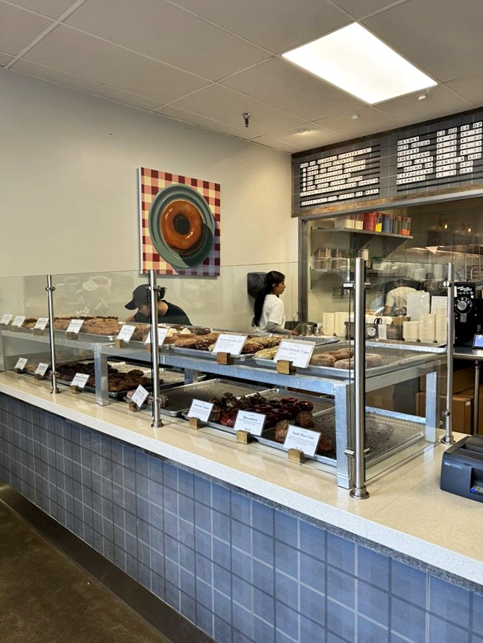 Where the magic happens! These donut wizards are crafting edible joy, one ring at a time. Willy Wonka, eat your heart out!