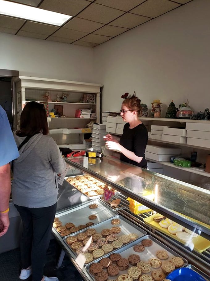 Donut whisperers at work! The friendly staff here are like fairy godmothers, but instead of glass slippers, they're handing out sugary rings of joy.