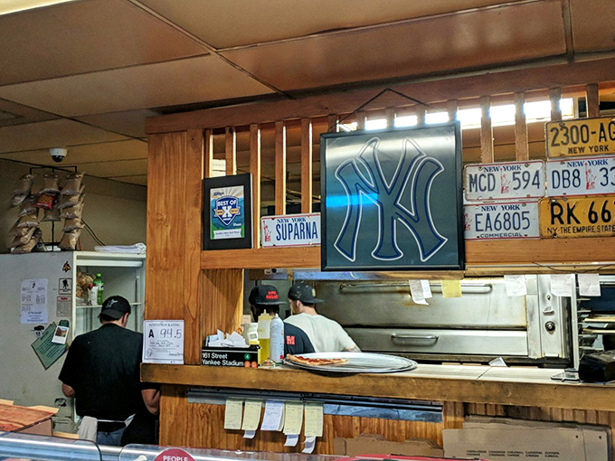 Pizza wizards at work! These guys could probably toss dough blindfolded while reciting the Yankees' lineup.