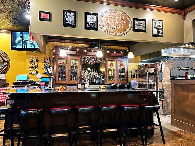 Raise a glass to good taste! The bar area invites you to unwind and toast to the perfect pizza night.