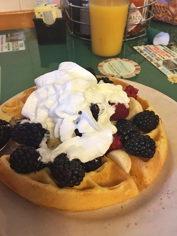 A waffle worthy of royalty! Crowned with berries and cream, it's the breakfast equivalent of winning the lottery.