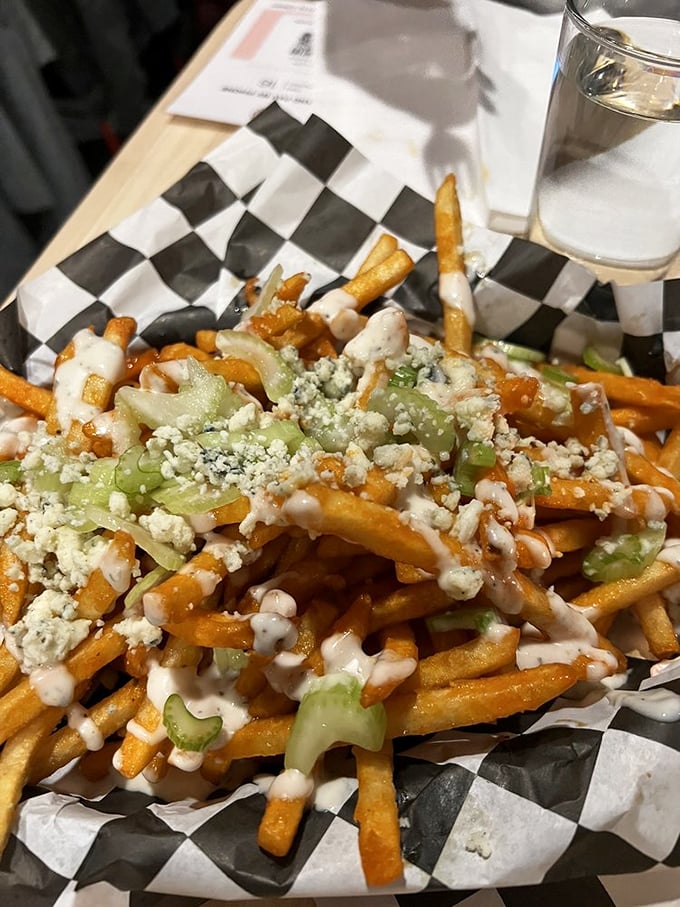 Buffalo fries, oh my! These zesty spuds topped with tangy blue cheese are like a flavor rodeo in your mouth. Giddy up and dig in!