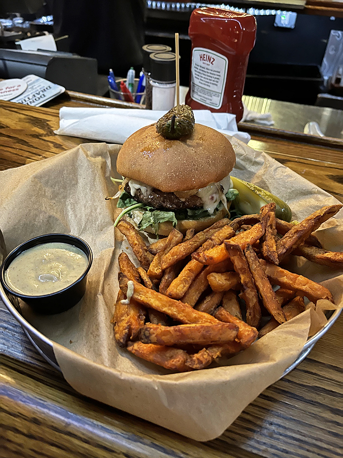 Meet the burger that'll make you forget about cheesesteaks! This towering beauty is a testament to the fact that sometimes, more is more. Especially when it comes to fries.