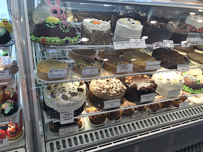 The cake display case&mdash;where willpower goes to die and "I'll just have coffee" turns into "Well, maybe just a slice."