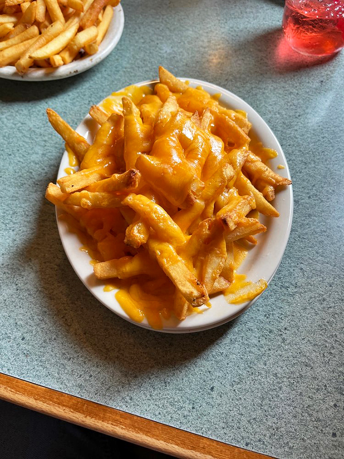 Cheese fries that don't apologize for being exactly what they are&mdash;a golden, gooey masterpiece that makes sharing feel like a personal sacrifice.
