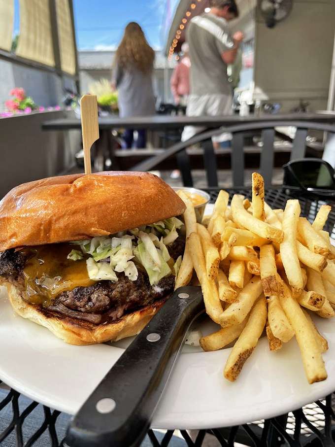 A burger that demands a two-handed commitment and provides the perfect excuse to skip dinner conversation entirely.