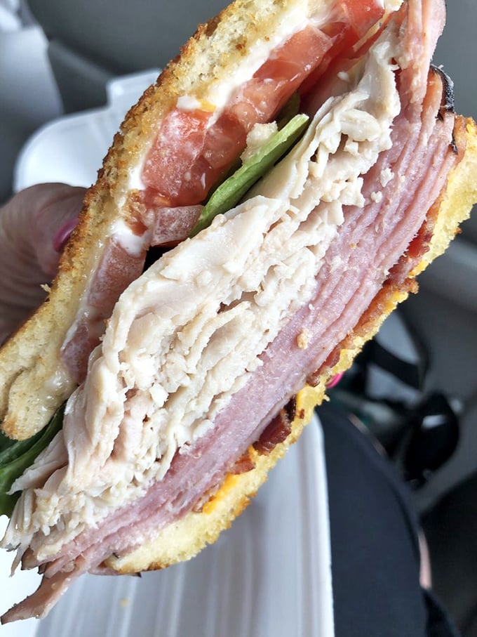 Now that's what I call a sandwich! This club's stacked higher than a Jenga tower, and twice as satisfying.
