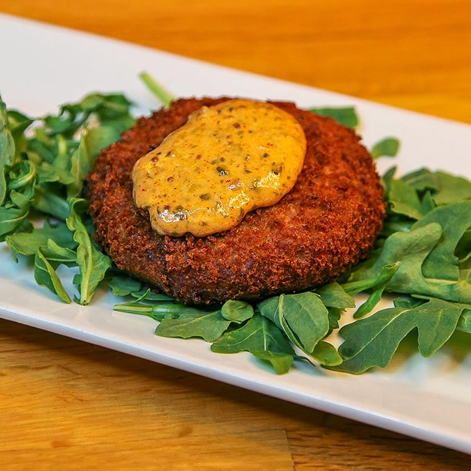 A crab cake so golden and crisp, it could make Poseidon himself swap his trident for a fork.