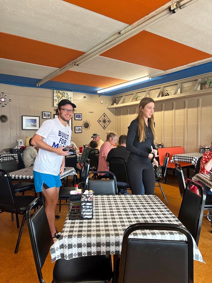 Happy diners, colorful decor, and the promise of good eats. This scene is more inviting than a warm hug from grandma.
