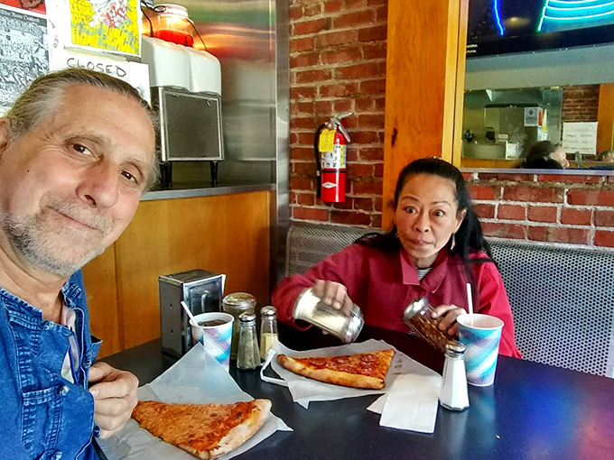 A picture-perfect pizza moment! These diners know the secret to happiness is a hot slice and good company.