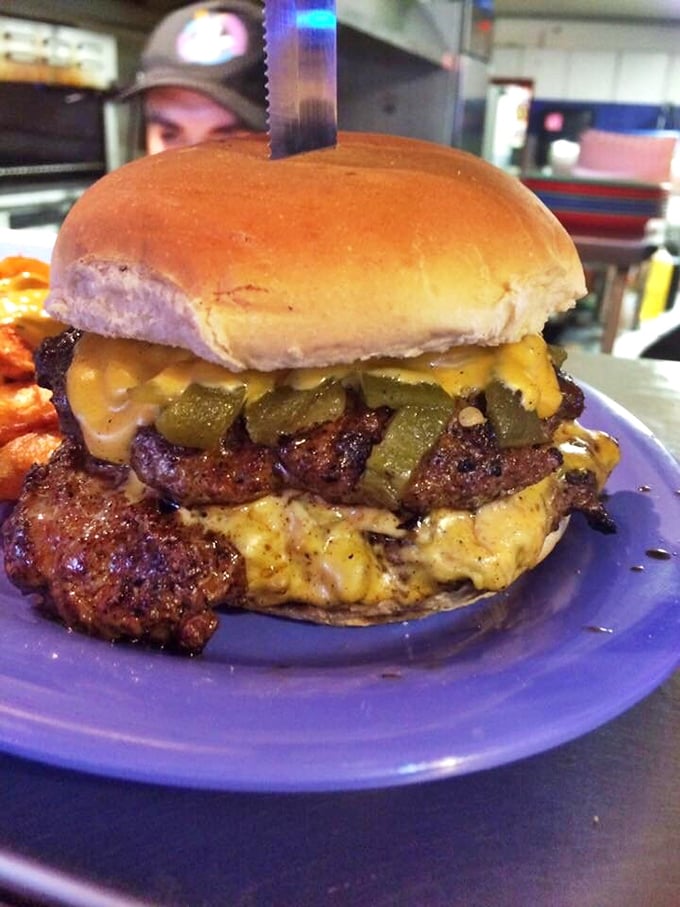 Behold the legendary green chile cheeseburger in its natural habitat &ndash; the perfect marriage of beef, spice, and molten cheese.