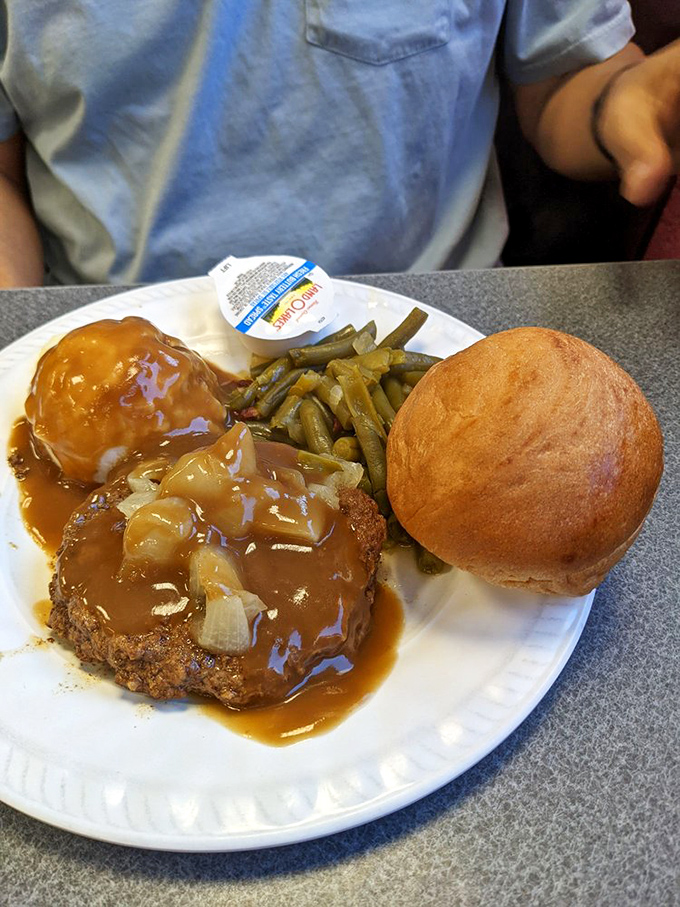 Gravy so good, you'll want to swim in it! This hamburger steak special is comfort food elevated to an art form.