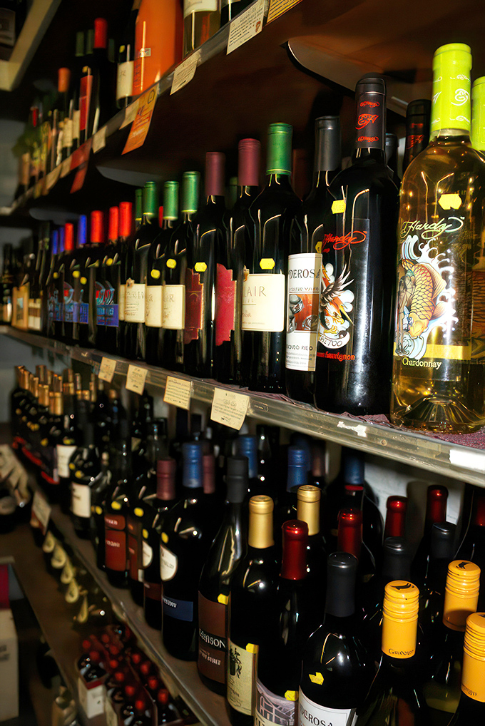 A rainbow of bottles promising liquid adventures. It's like an adult candy store, but with more sophisticated flavors and better stories.