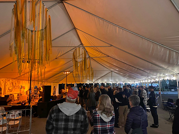 Evening festival lights transform ordinary tents into magical spaces, where music and laughter float upward like bubbles in a glass of champagne.