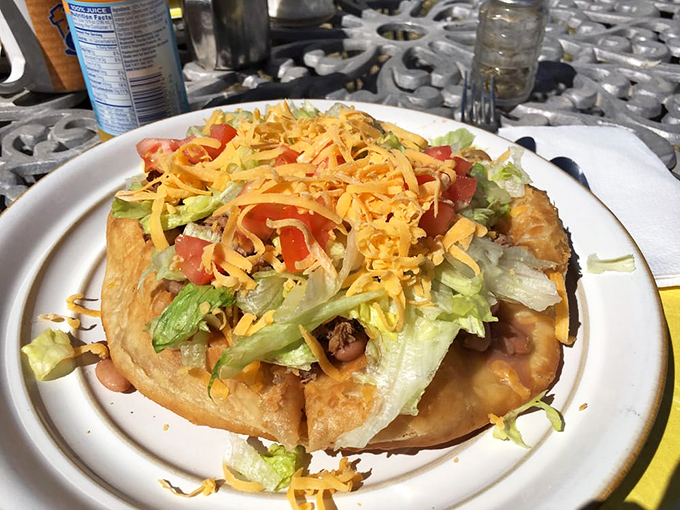 Behold the Navajo Taco, a culinary fusion that's part comfort food, part flavor explosion! It's like a fiesta decided to crash a picnic.