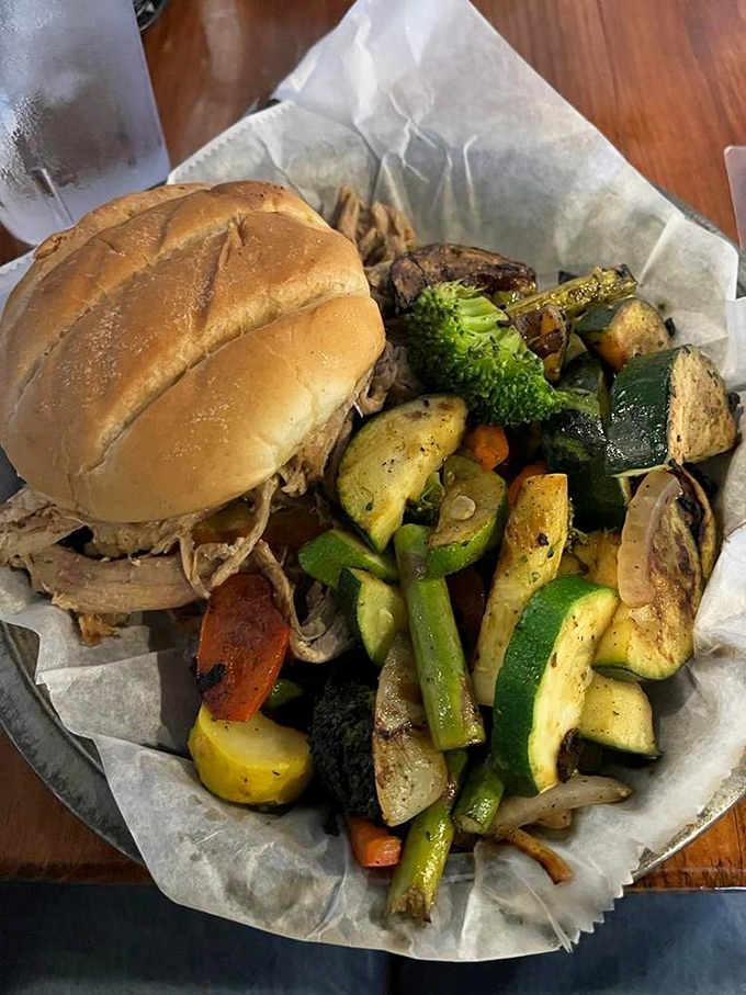 Who says BBQ can't be balanced? This pulled pork sandwich cozies up to a colorful veggie medley, proving opposites really do attract.