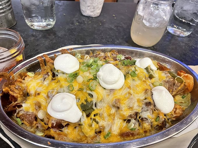 Not your average nachos &ndash; this mountain of melty cheese, pulled pork, and dollops of sour cream turns finger food into a full-contact sport.