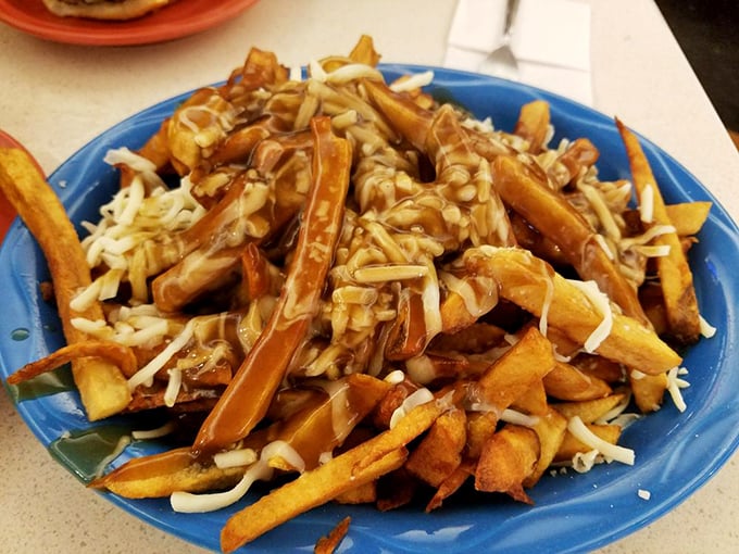 Poutine's American cousin! These Quebec-style fries are a melty, gooey, gravity-defying tower of deliciousness that would make a Mountie weep with joy.