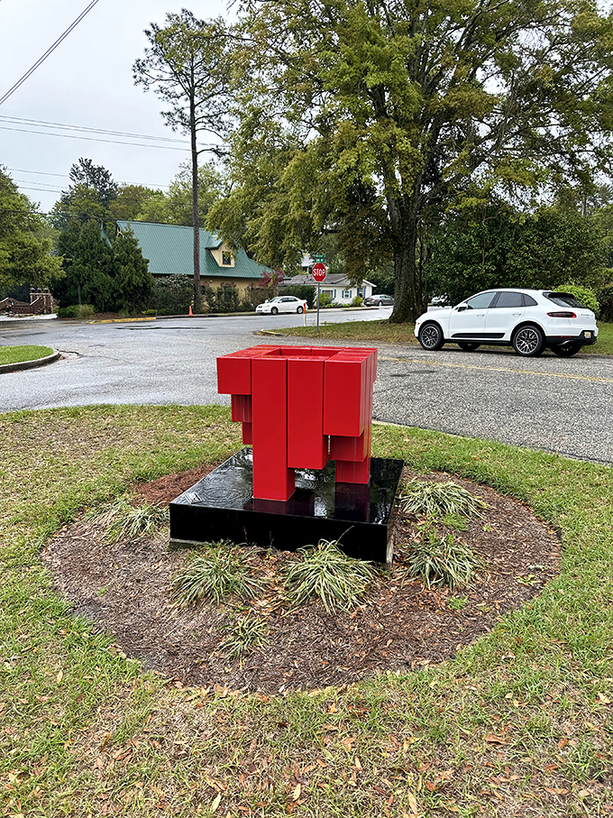 Is it modern art or a Transformer taking a nap? This bold red sculpture adds a pop of contemporary magic to the storybook scene.