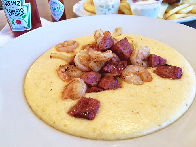 Shrimp and grits elevated to an art form&mdash;creamy cornmeal canvas topped with perfectly seasoned shrimp and sausage. Southern comfort reimagined.