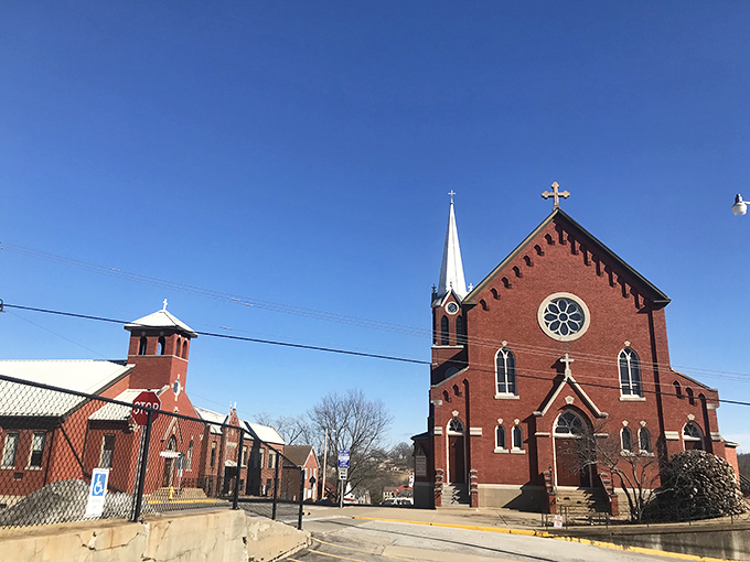 St. George Catholic Church's twin spires reach skyward like spiritual exclamation points, its red brick solidity a testament to faith built to withstand centuries.