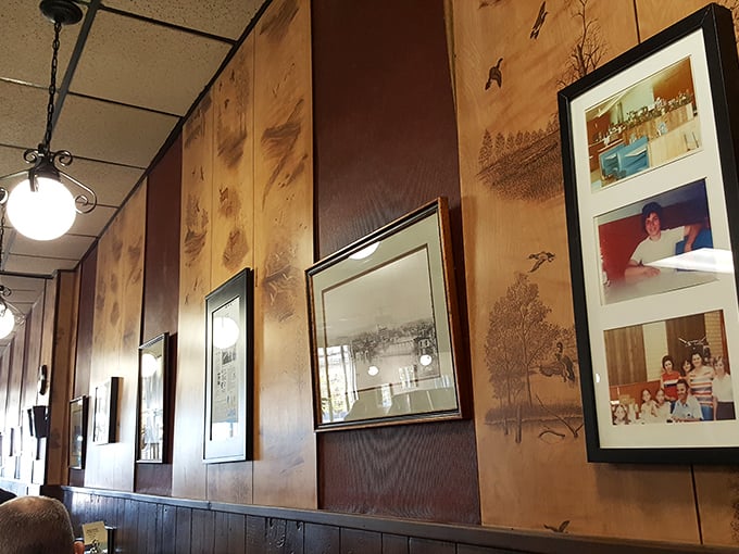 A gallery of memories on wood-paneled walls. Each photo tells a story, much like the dishes served here.