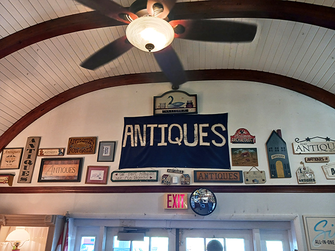 A wall of words that speaks volumes! This quirky collection of signs is like a greatest hits album of antique store humor. Dad jokes, anyone?