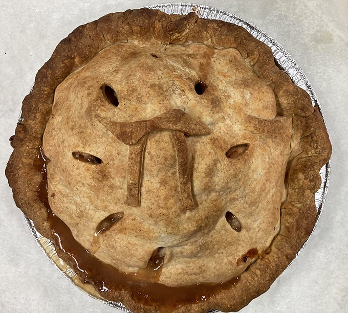 This isn't just apple pie; it's a work of art with a crust. The "pi" symbol on top? That's baker humor at its finest.