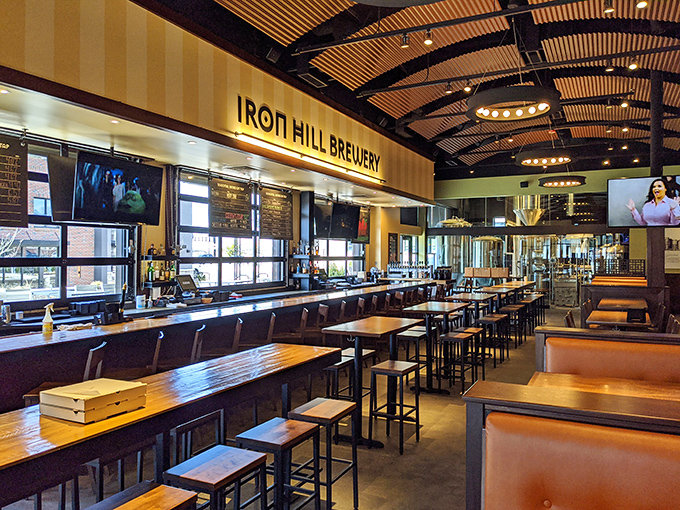 A bar that stretches toward possibility, where beer taps stand like sentinels guarding liquid treasure. Where decisions are deliciously difficult.