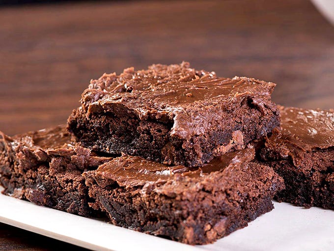 Brownies so dense with chocolate they have their own gravitational pull. The kind of dessert that makes you wonder why humans ever bothered inventing anything else.