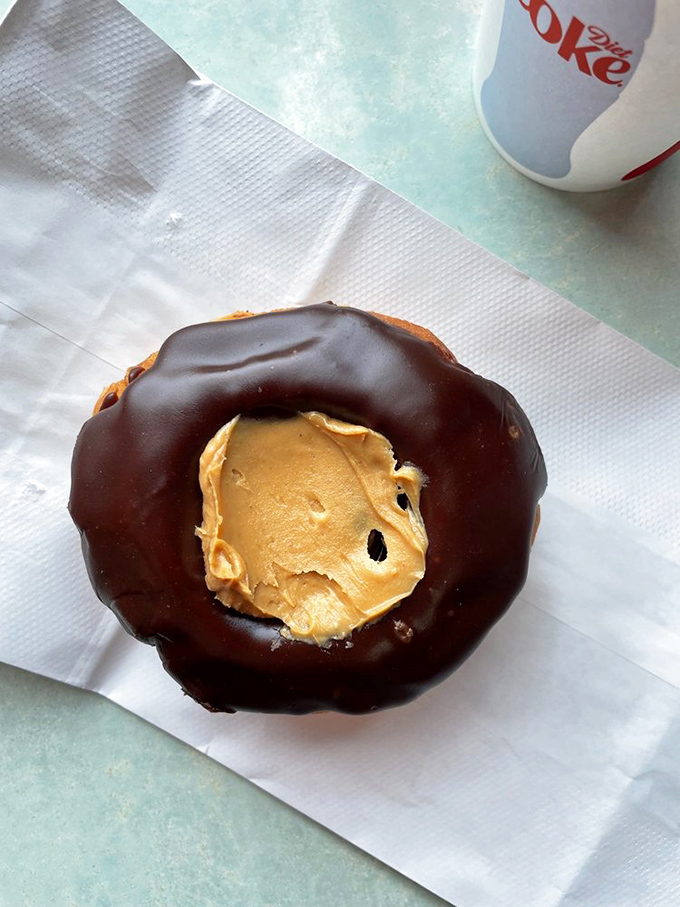 Meet the star of the show – the Buckeye Donut! Part chocolate, part peanut butter, all Ohio. It's like the state fair in pastry form, minus the livestock.