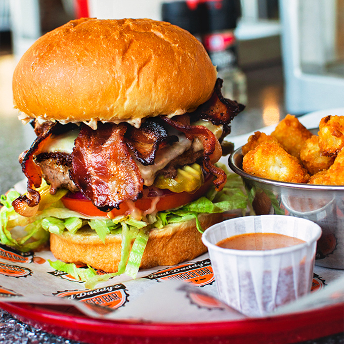 Ladies and gentlemen, meet the burger of your dreams! This towering masterpiece is so photogenic, it probably has its own Instagram account. #BurgerGoals