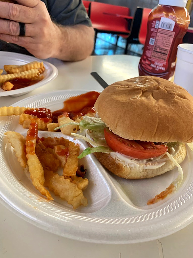A burger that requires both hands and several napkins. The crinkle-cut fries aren't just sides&mdash;they're essential supporting characters in this lunch drama.