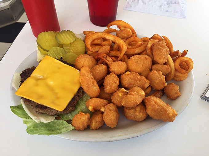 A burger platter that's not fooling around. Those cheese curds are the supporting actors stealing the show!