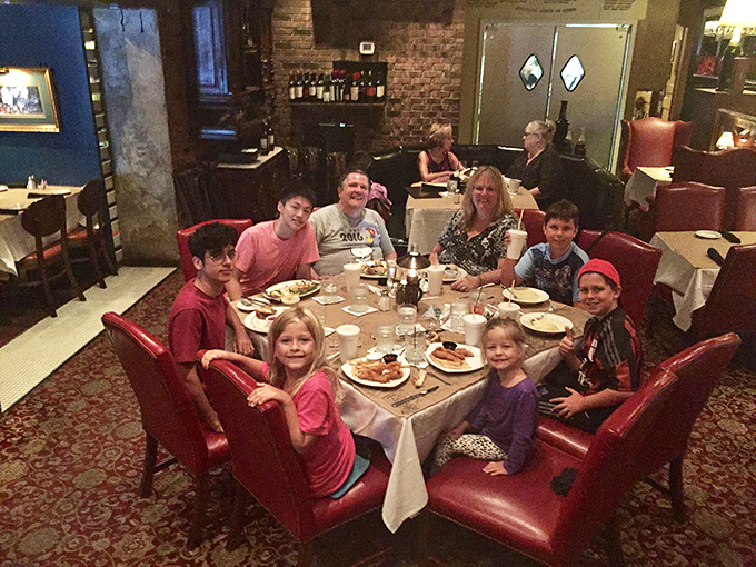 Family dinner goals achieved! This scene is warmer than a lobster bisque, proving that good food brings people together better than any social media app.