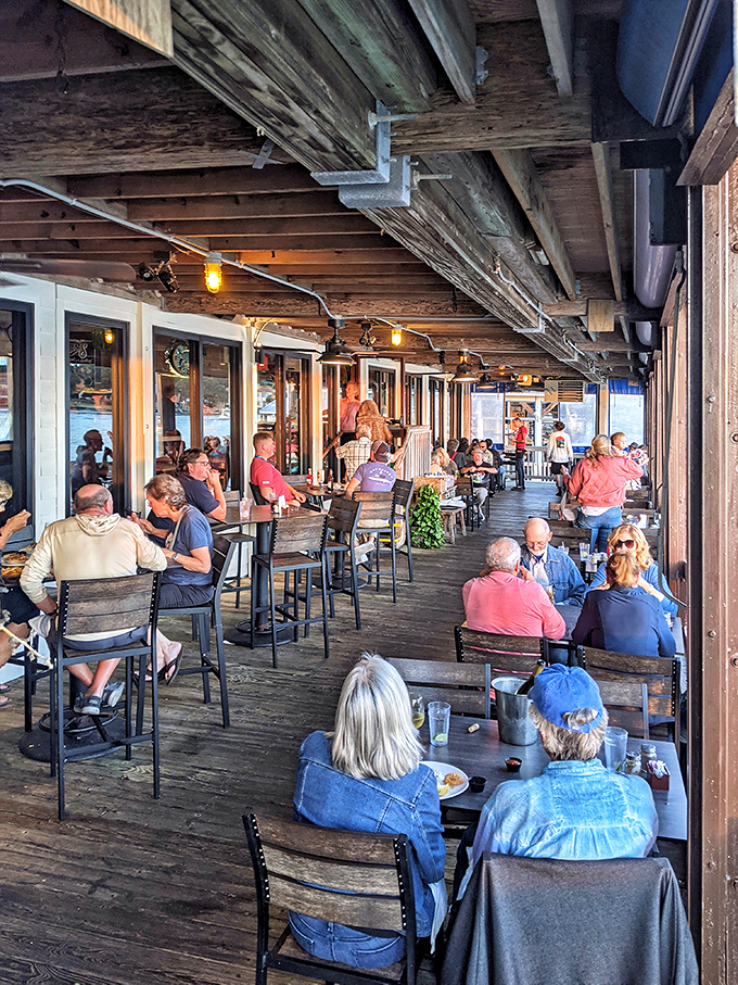 A bustling deck filled with happy diners. It's like a friendly neighborhood block party, but with better seafood and a killer waterfront view.