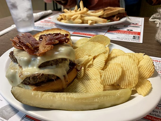 This isn't just a cheeseburger; it's a tower of power. It's the Leaning Tower of Cheesa, if you will. Pisa's got nothing on this beauty.