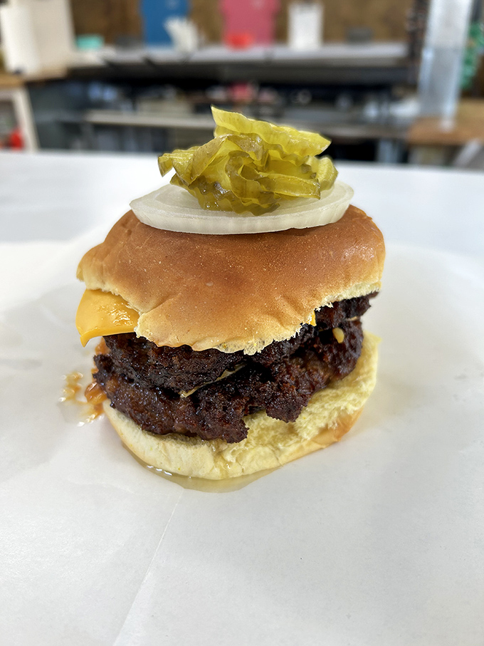 The tower of power! This double cheeseburger is stacked higher than a Jenga game at a giants' convention.