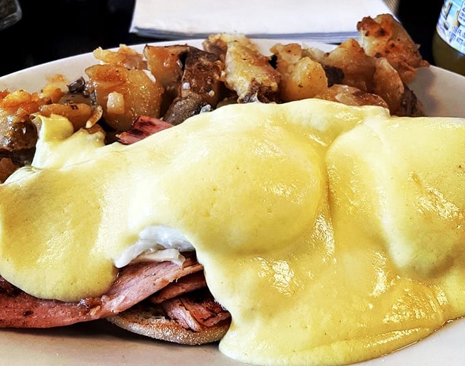 Eggs Benedict that could make a hen proud. These golden orbs, draped in hollandaise, sit atop their English muffin thrones like breakfast royalty.