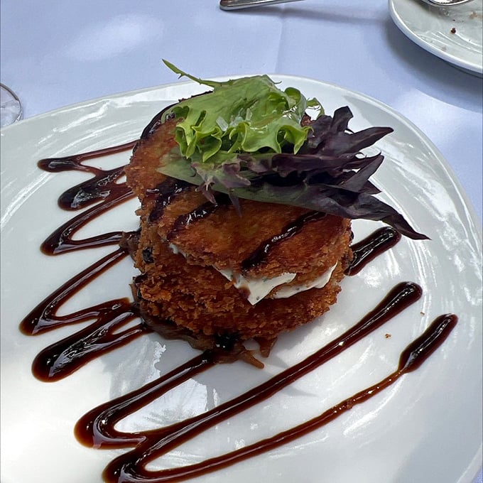 Fried green tomatoes that would make Fannie Flagg proud. These golden discs of Southern comfort are a crispy, tangy delight.
