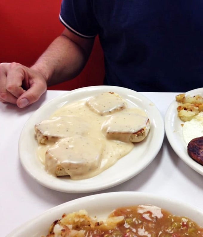 Gravy train coming through! These biscuits are drowning in a creamy river of goodness that'll make your arteries beg for mercy (but your taste buds will thank you).