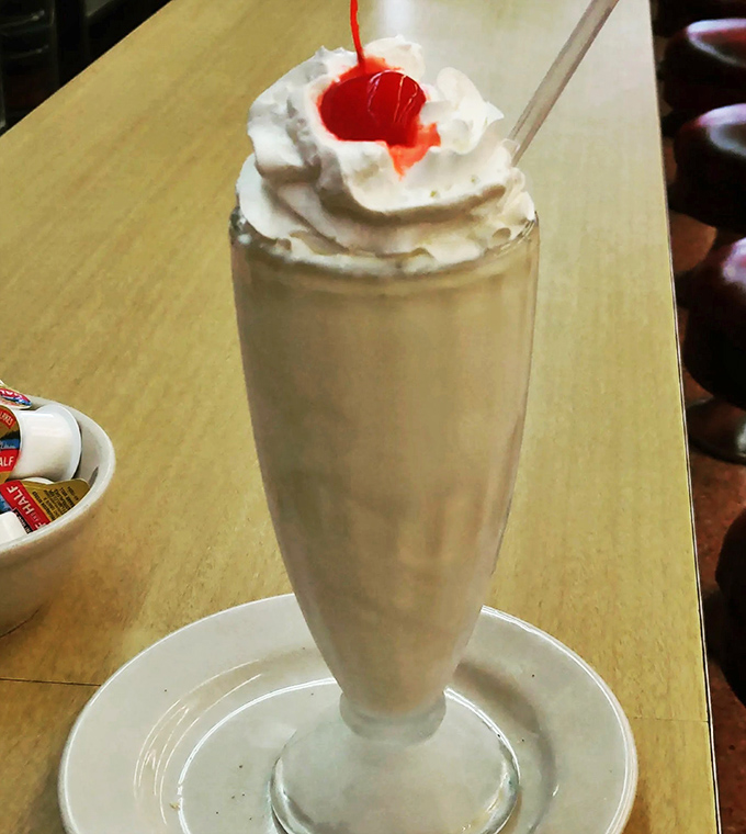 Creamy dreamy perfection! This milkshake isn't just a drink; it's a work of art topped with a cloud of whipped cream and a cherry on top. Picasso, eat your heart out!