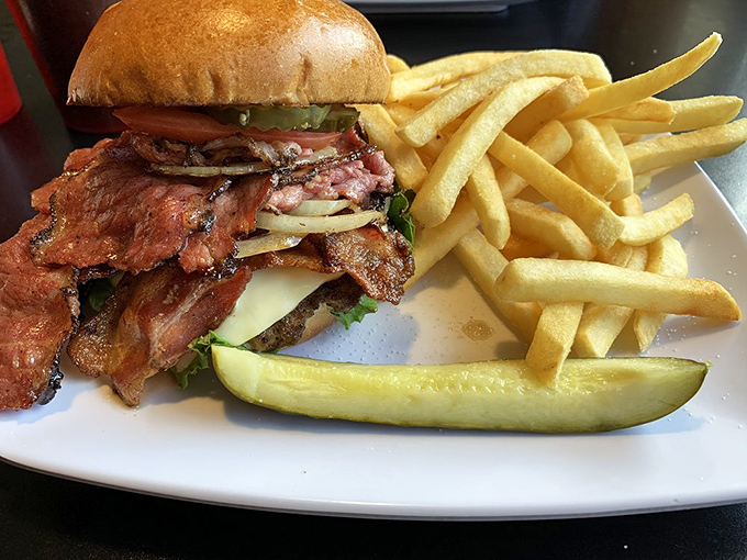 A burger that requires both hands, strategic planning, and possibly a nap afterward. That pickle isn't a garnish &ndash; it's essential structural support.