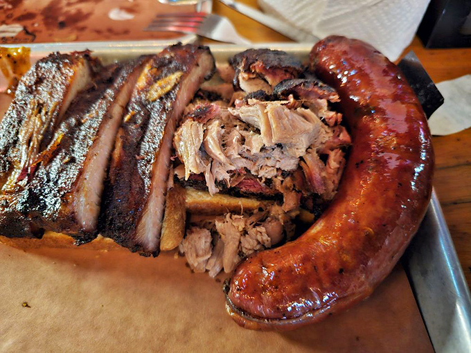 The barbecue trinity: ribs, pulled pork, and that jalape&ntilde;o cheddar sausage. This plate isn't a meal&mdash;it's a religious experience.