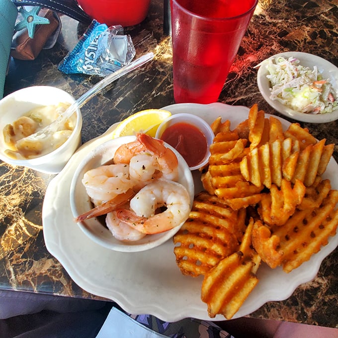 A seafood trifecta that's hard to beat. Succulent shrimp, waffle fries, and tangy slaw - it's like a beach party on a plate!